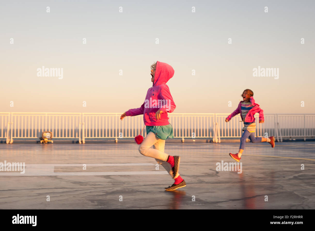 Kids running around on ferry deck Stock Photo - Alamy