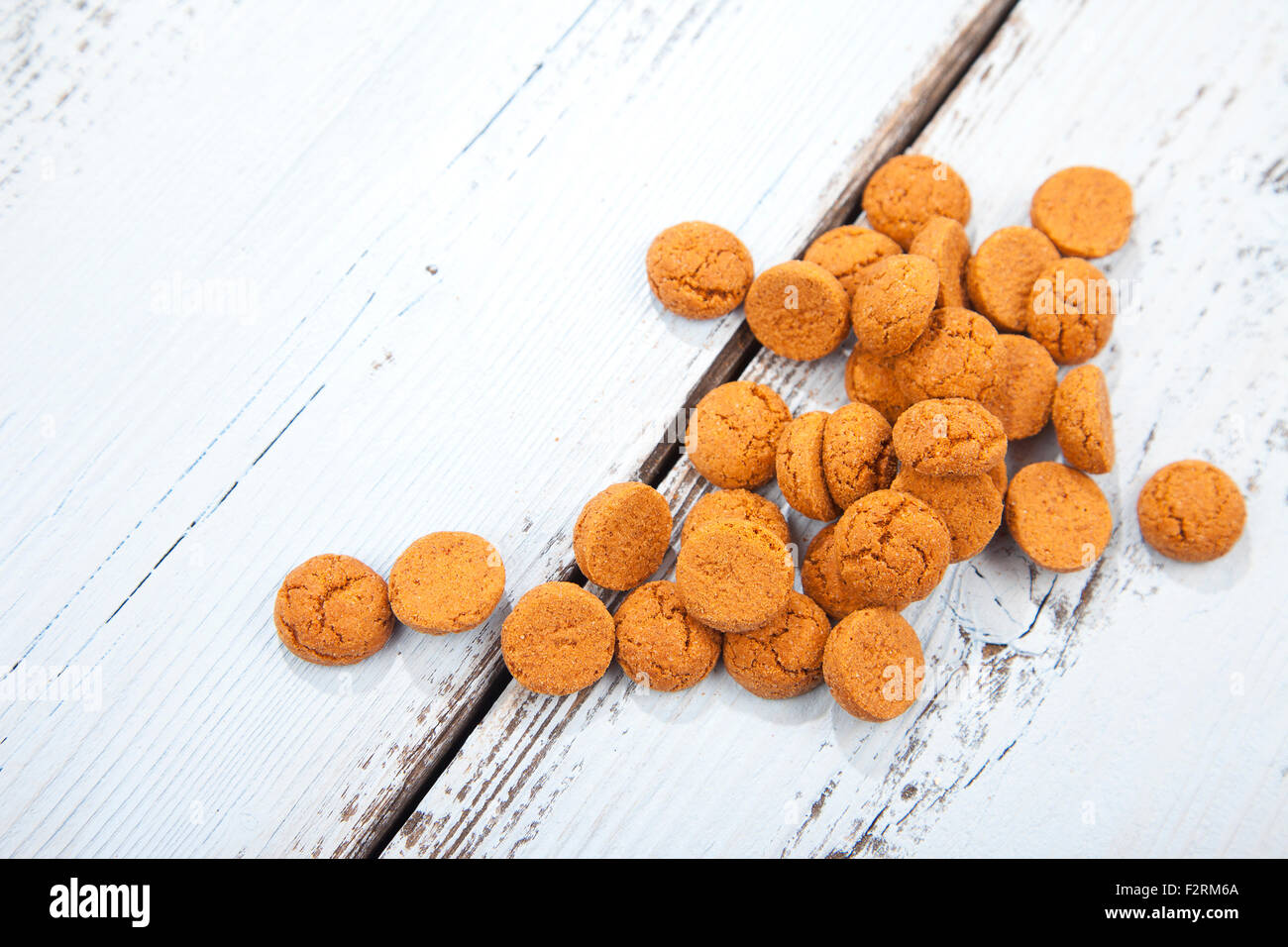 Pile of Dutch candy pepernoot on white wooden background Stock Photo ...