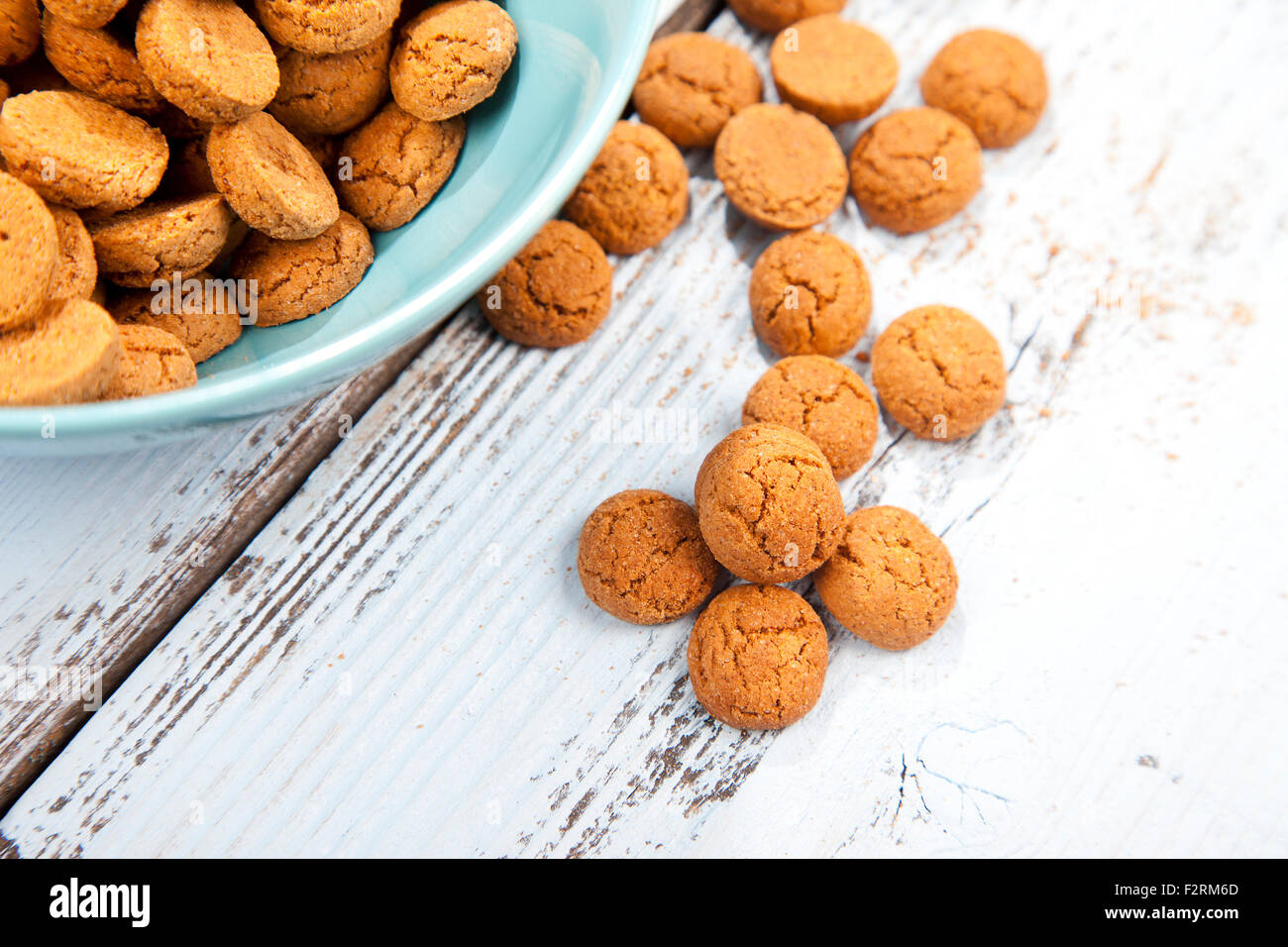 Dutch candy pepernoot with bowl on white wooden background Stock Photo ...