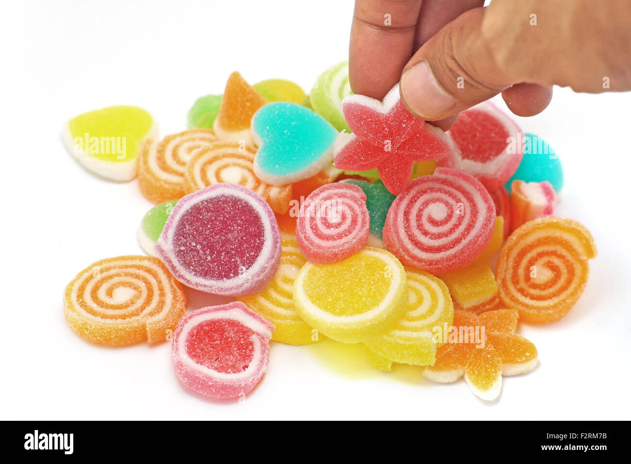 human hand pick up jelly sweet candy isolated on white background Stock ...