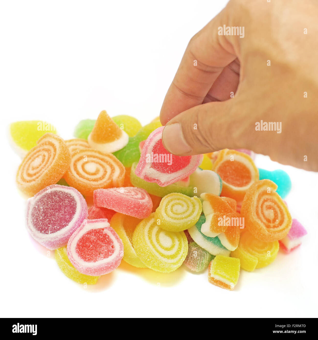 human hand pick up jelly sweet candy isolated on white background Stock ...