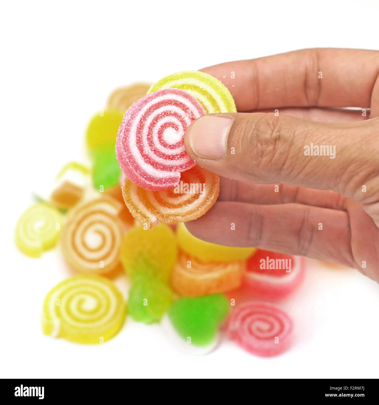 human hand pick up jelly sweet candy isolated on white background Stock ...