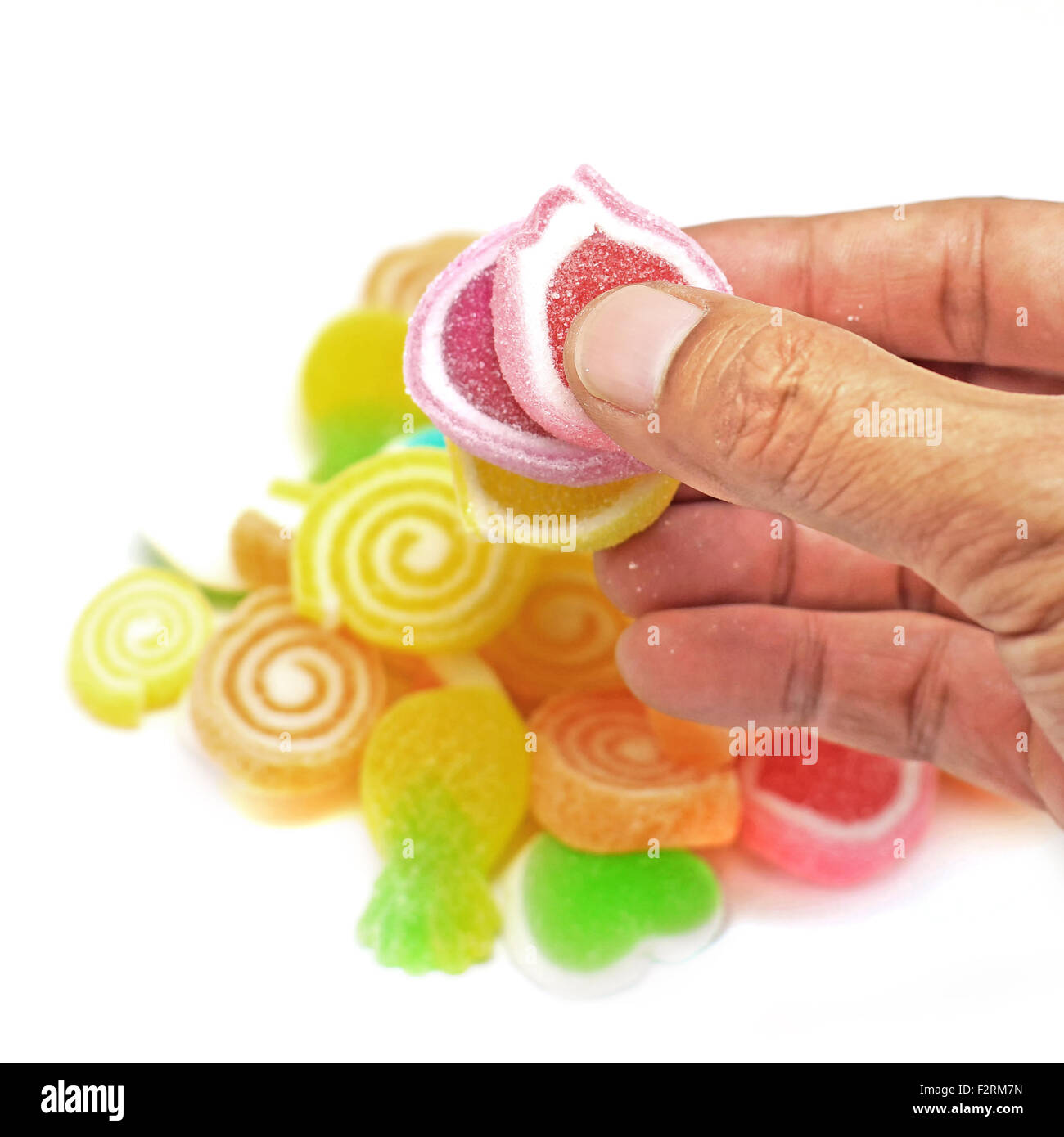 human hand pick up jelly sweet candy isolated on white background Stock ...