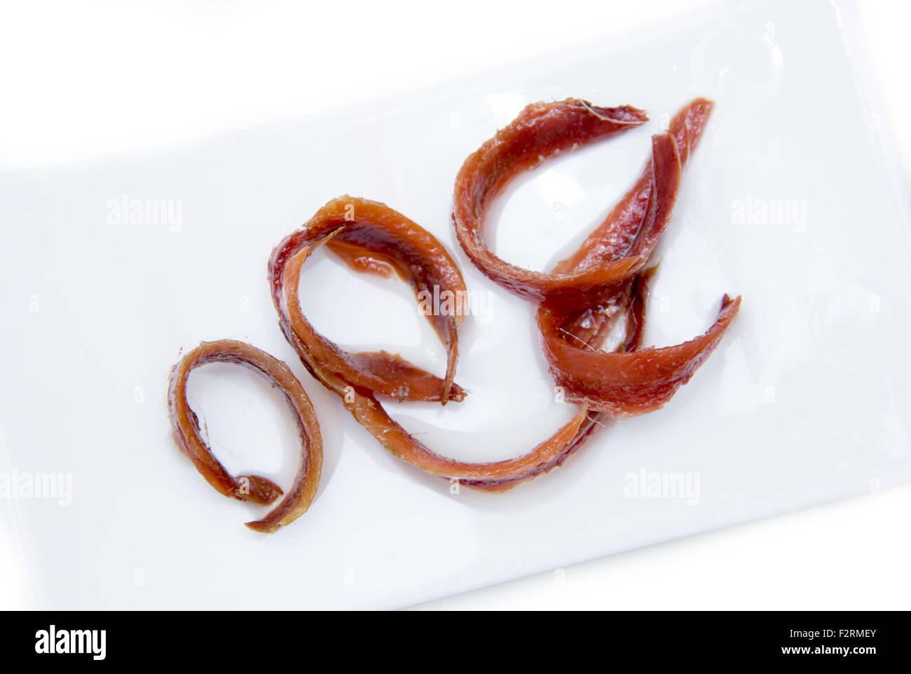 Anchovy fillets on tray on a white background seen from above Stock ...