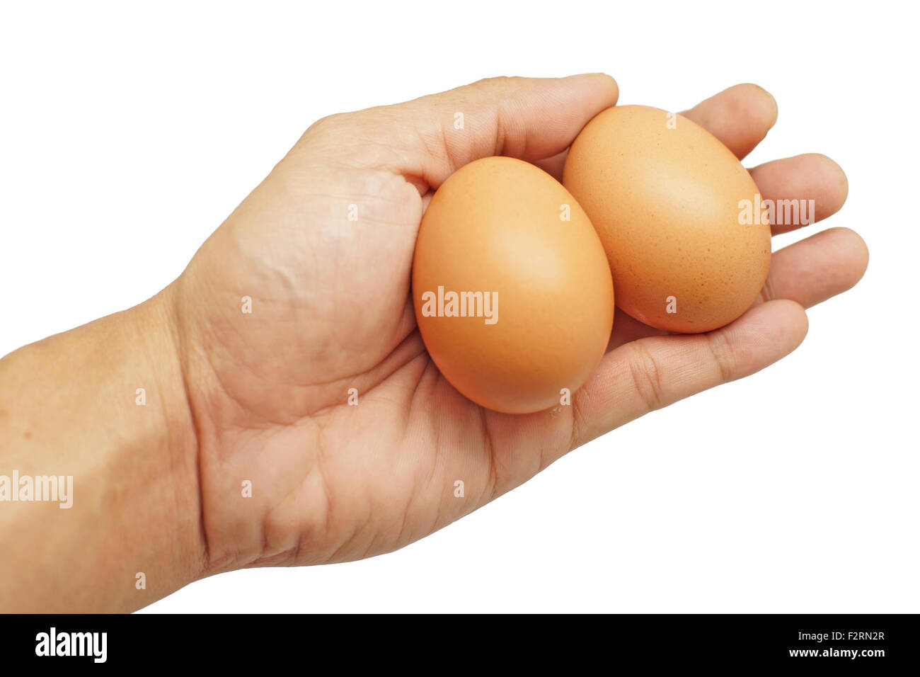 two eggs in male hand isolated on white background Stock Photo - Alamy