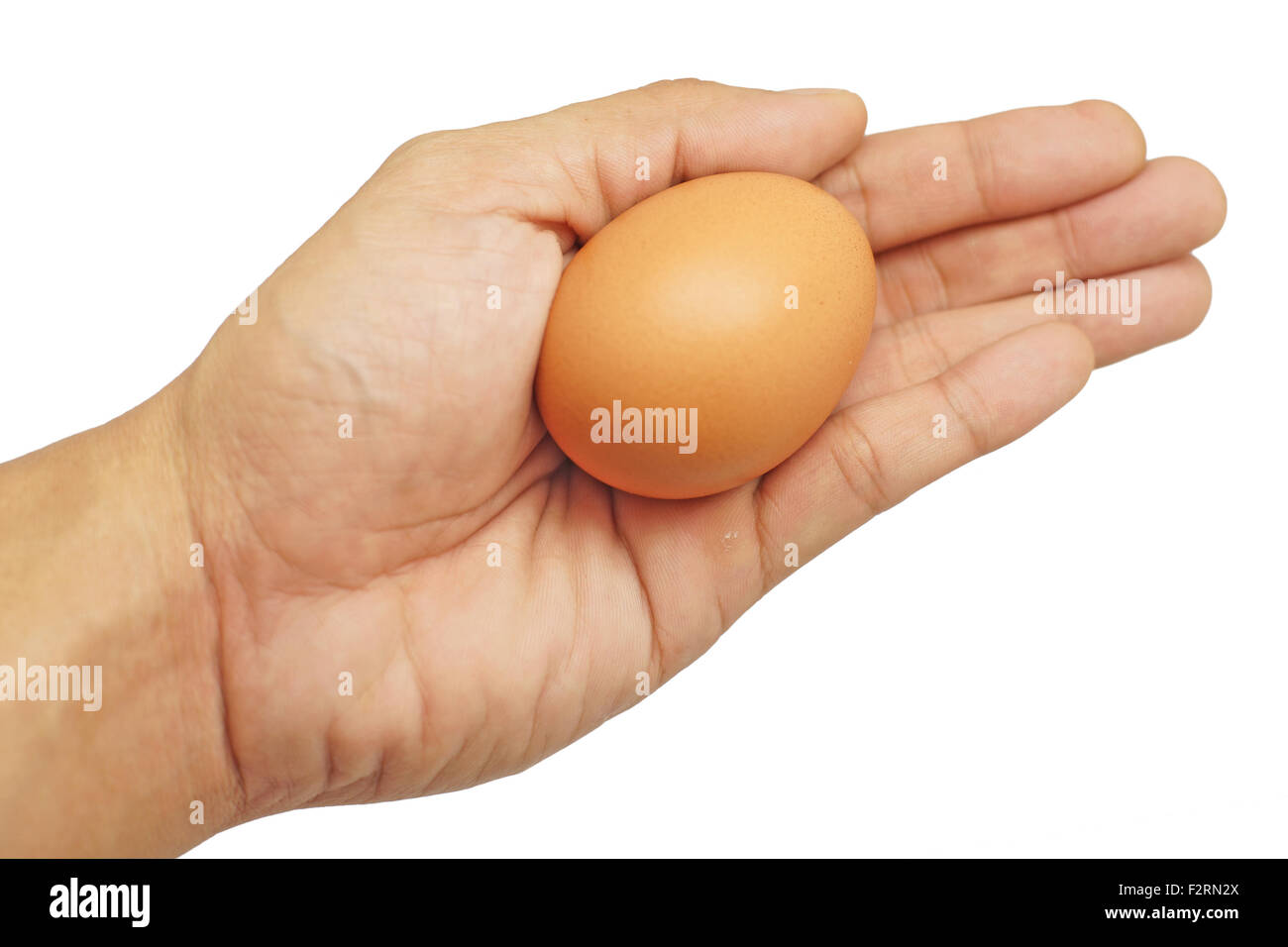 egg in male hand isolated on white background Stock Photo - Alamy