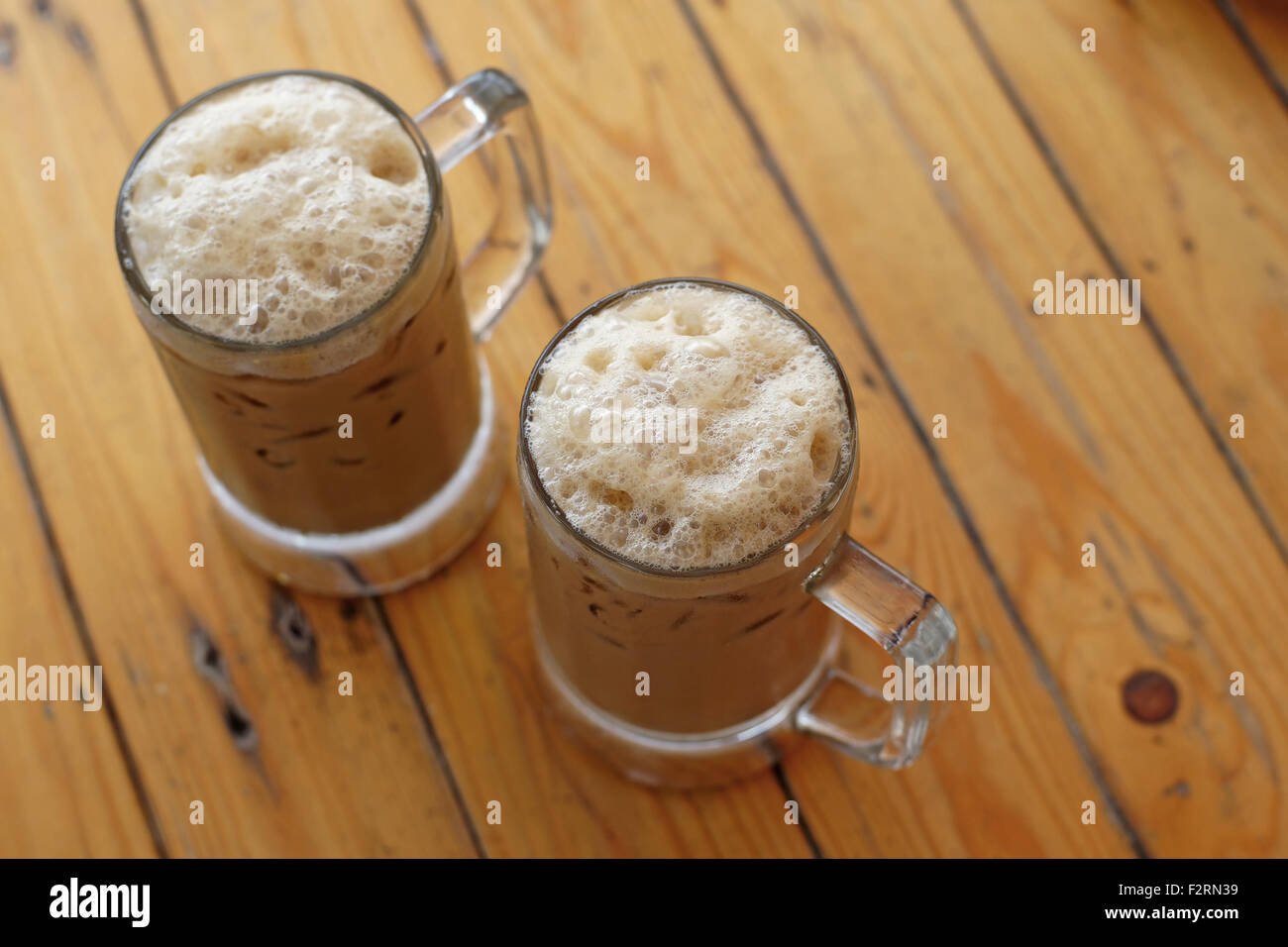 iced coffee on wooden table background Stock Photo - Alamy