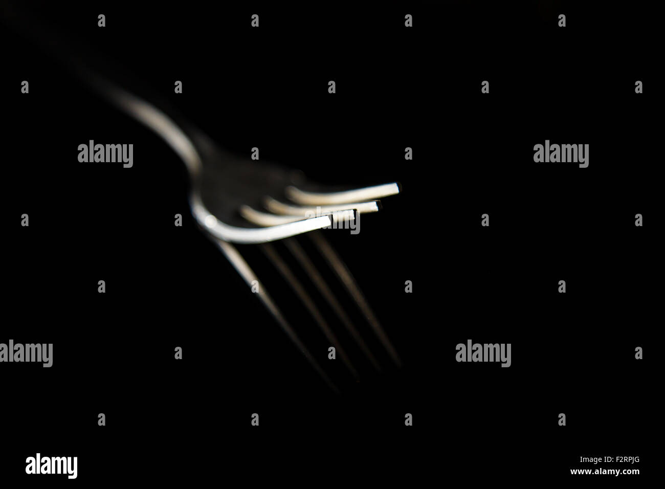fork isolated on a black background Stock Photo - Alamy