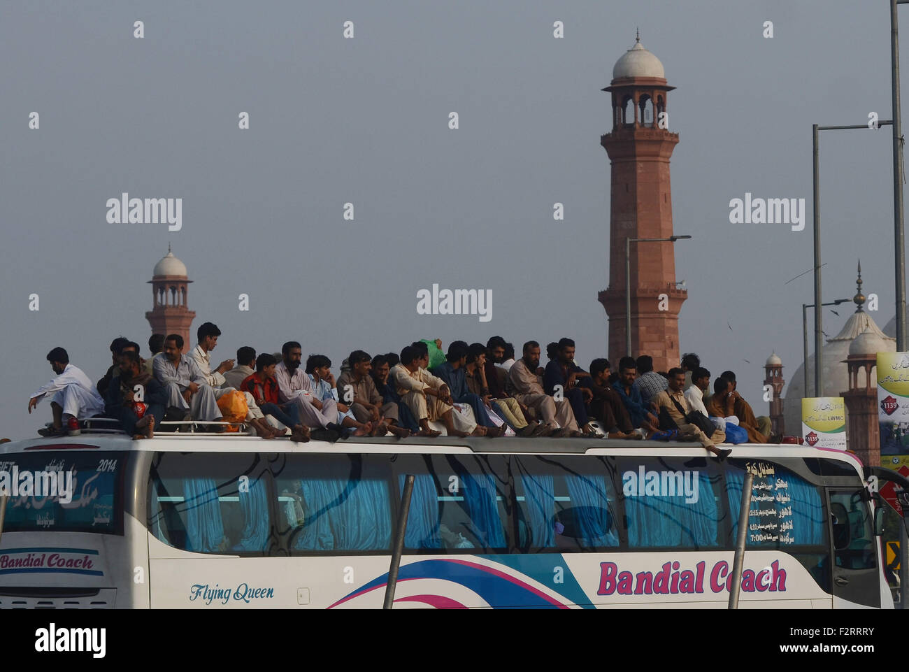 Lahore, Pakistan. 23rd Sep, 2015. An overloaded bus with passengers ...
