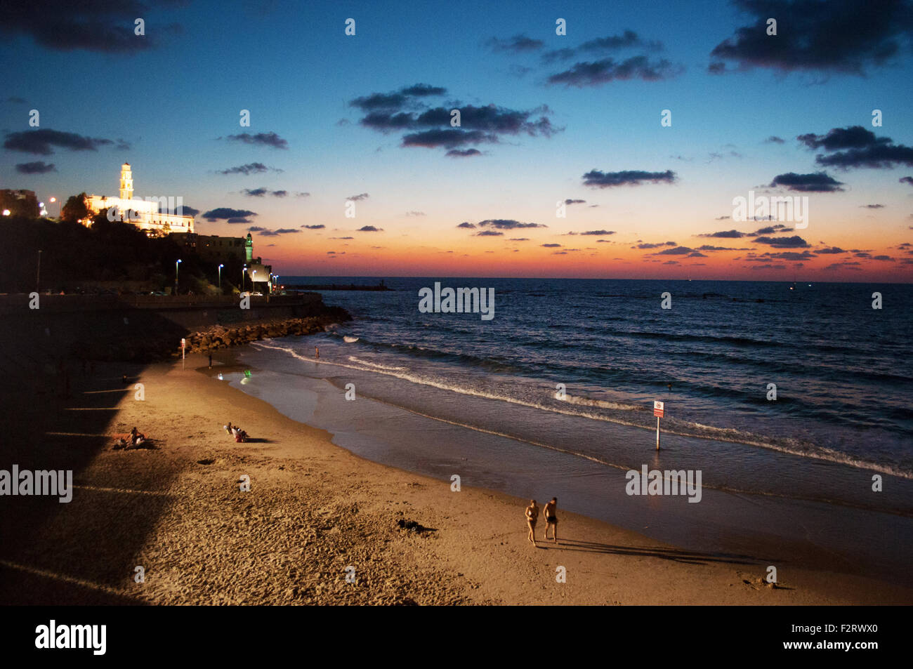 Summer day, people, sunset, beach, tower bell of Saint Peter Church and ...