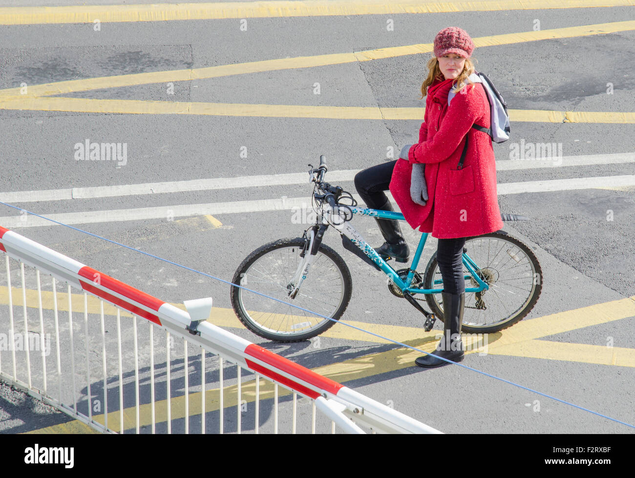 Cyclist waiting at level crossing barriers hi-res stock photography and ...