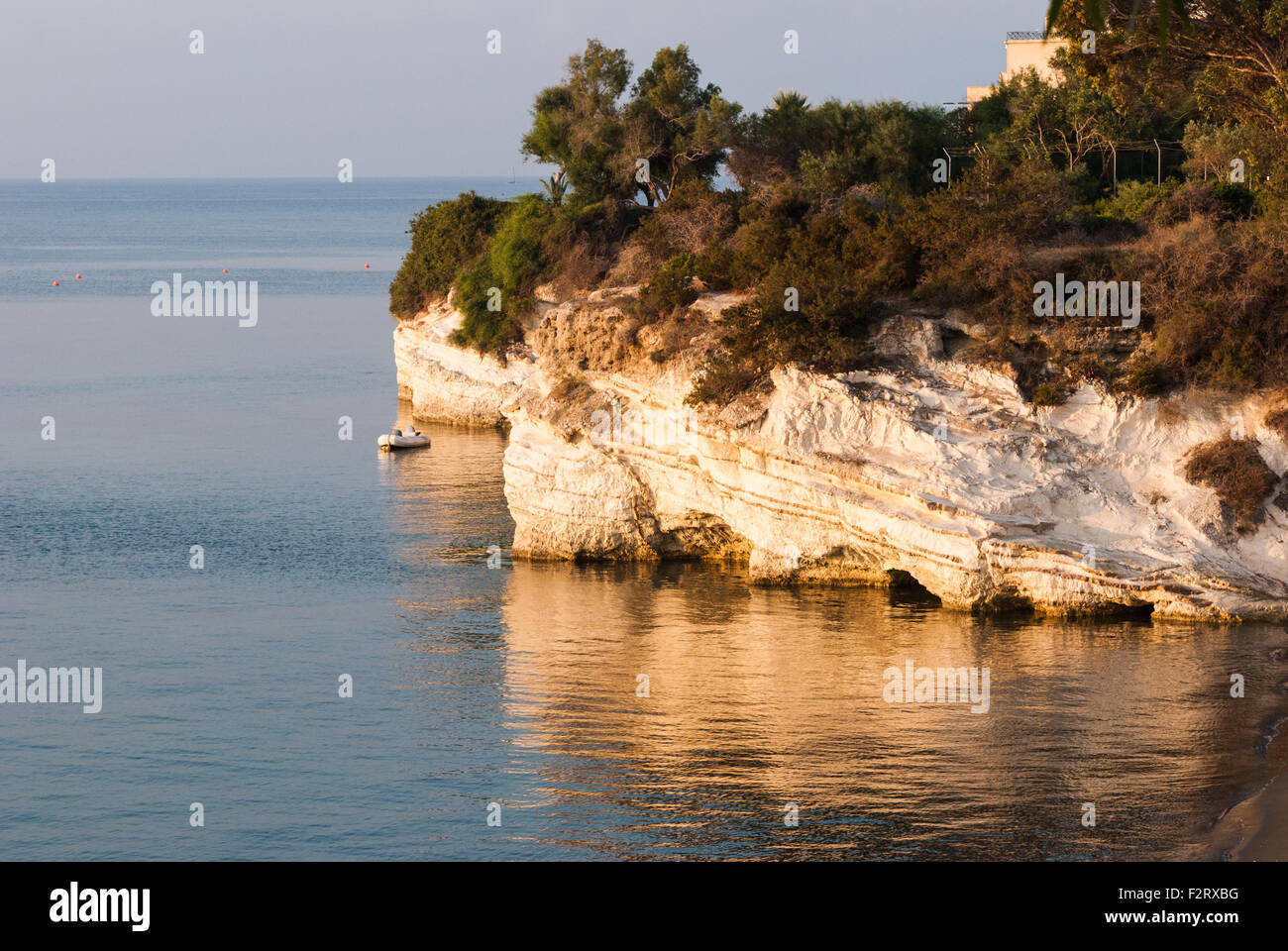 Cliff at the sunset with reflection in the water. Governor beach ...