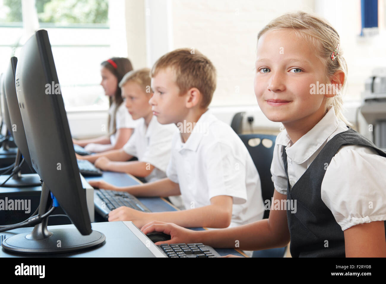 Group Of Elementary Pupils In Computer Class With Teacher Stock Photo ...