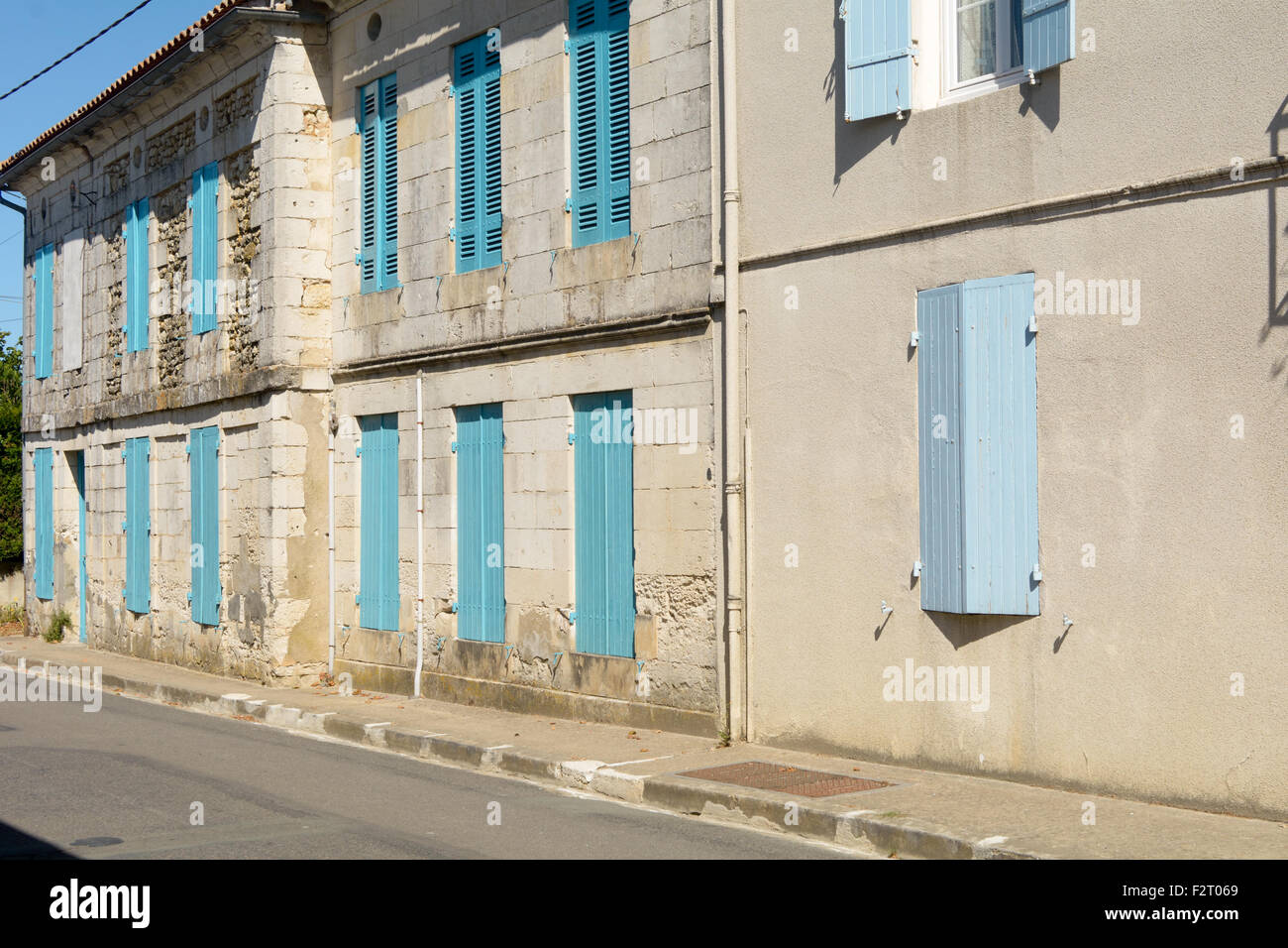Homes with blue shutters closed in France Stock Photo - Alamy
