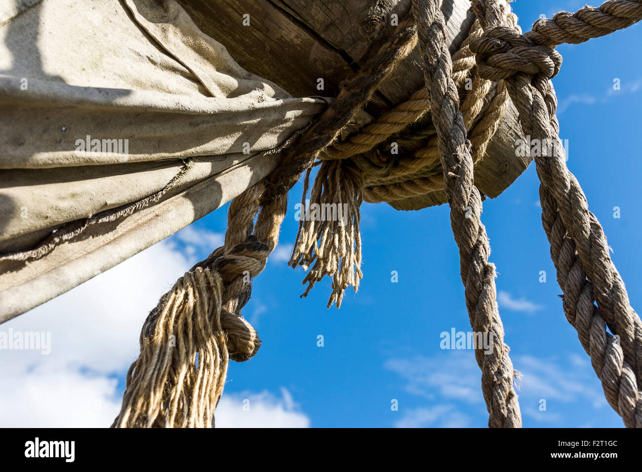 Old ragged sailing rigging an ancient sailing vessel against cloudy sky ...
