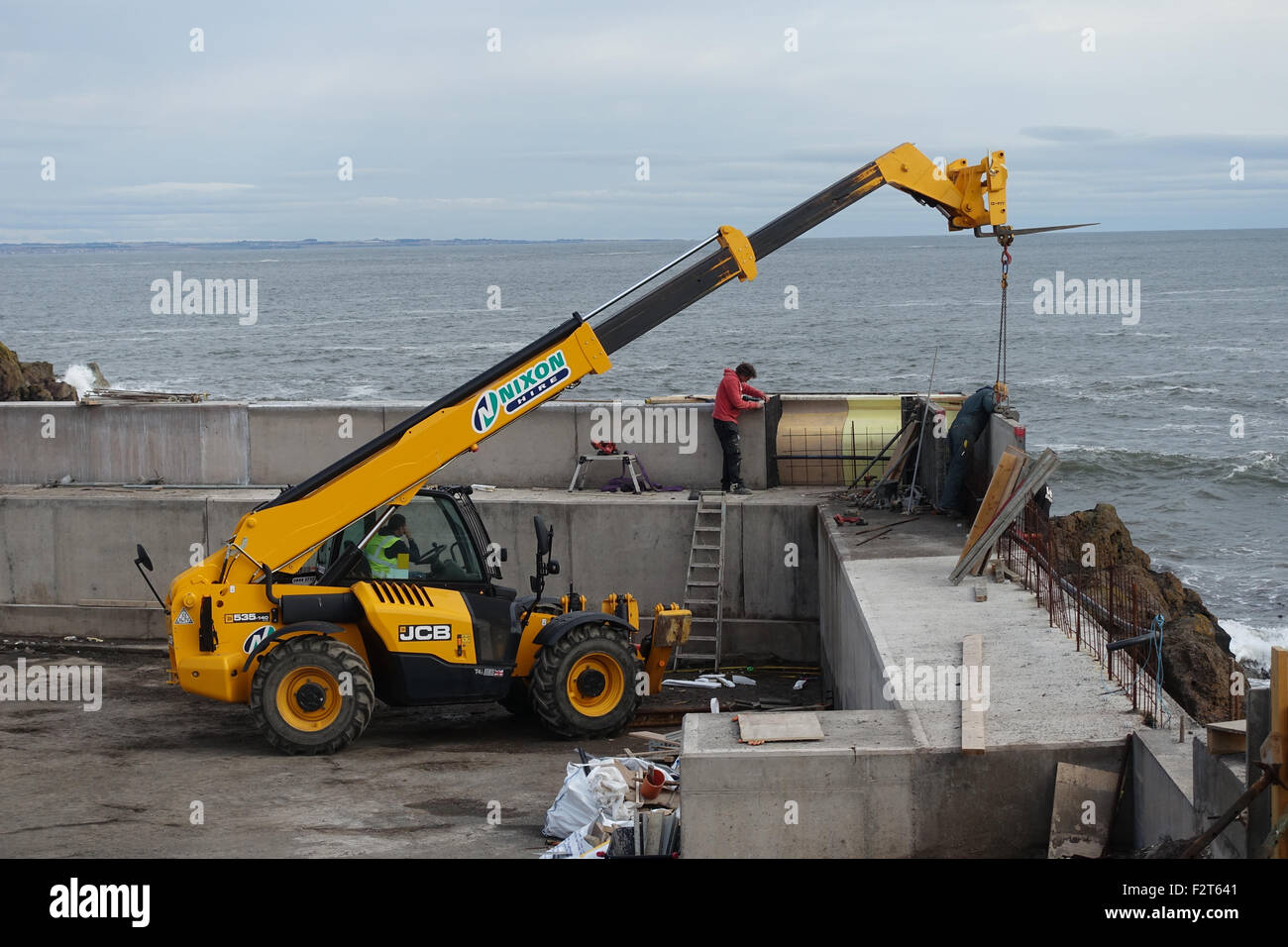 Building sea defence wall Stock Photo - Alamy