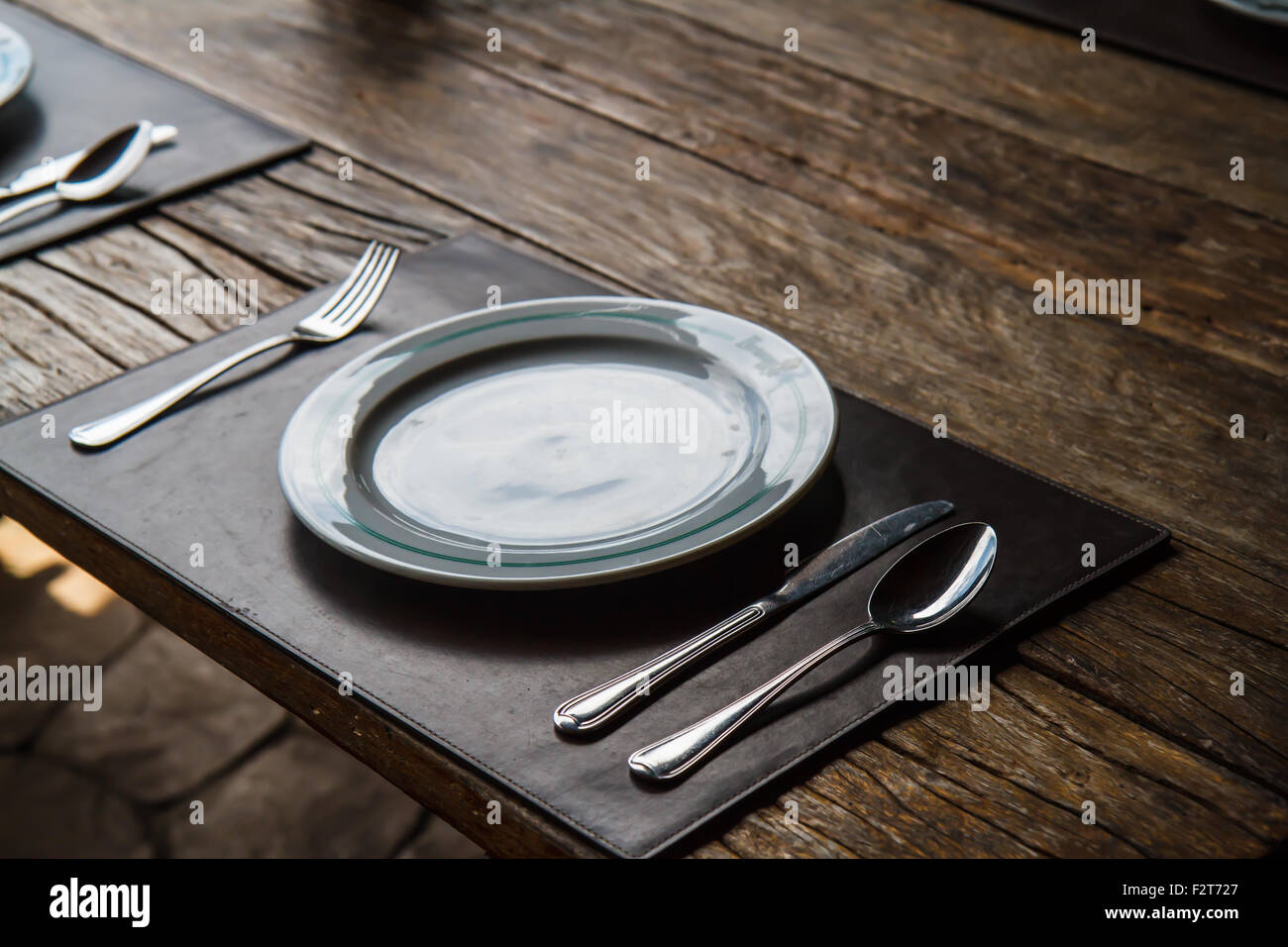 Plate fork spoon on the table Stock Photo - Alamy