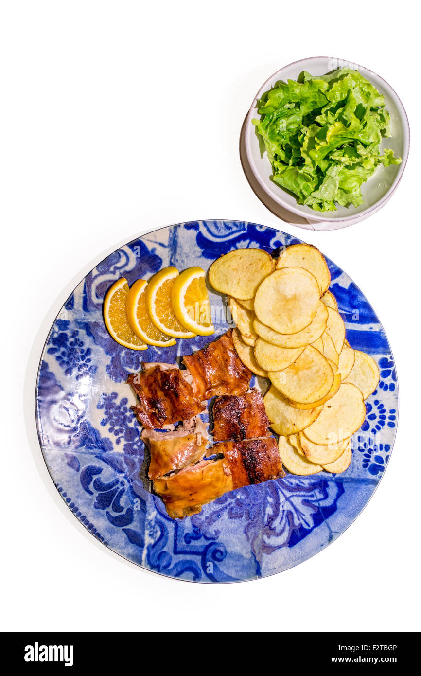 roasted pig with potatoes, lemon, and salad Stock Photo - Alamy