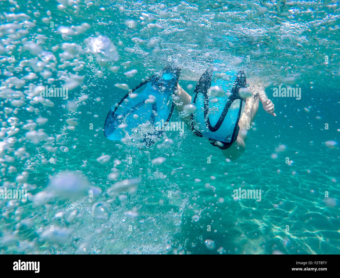 Flippers moving through water with air bubbles Stock Photo - Alamy