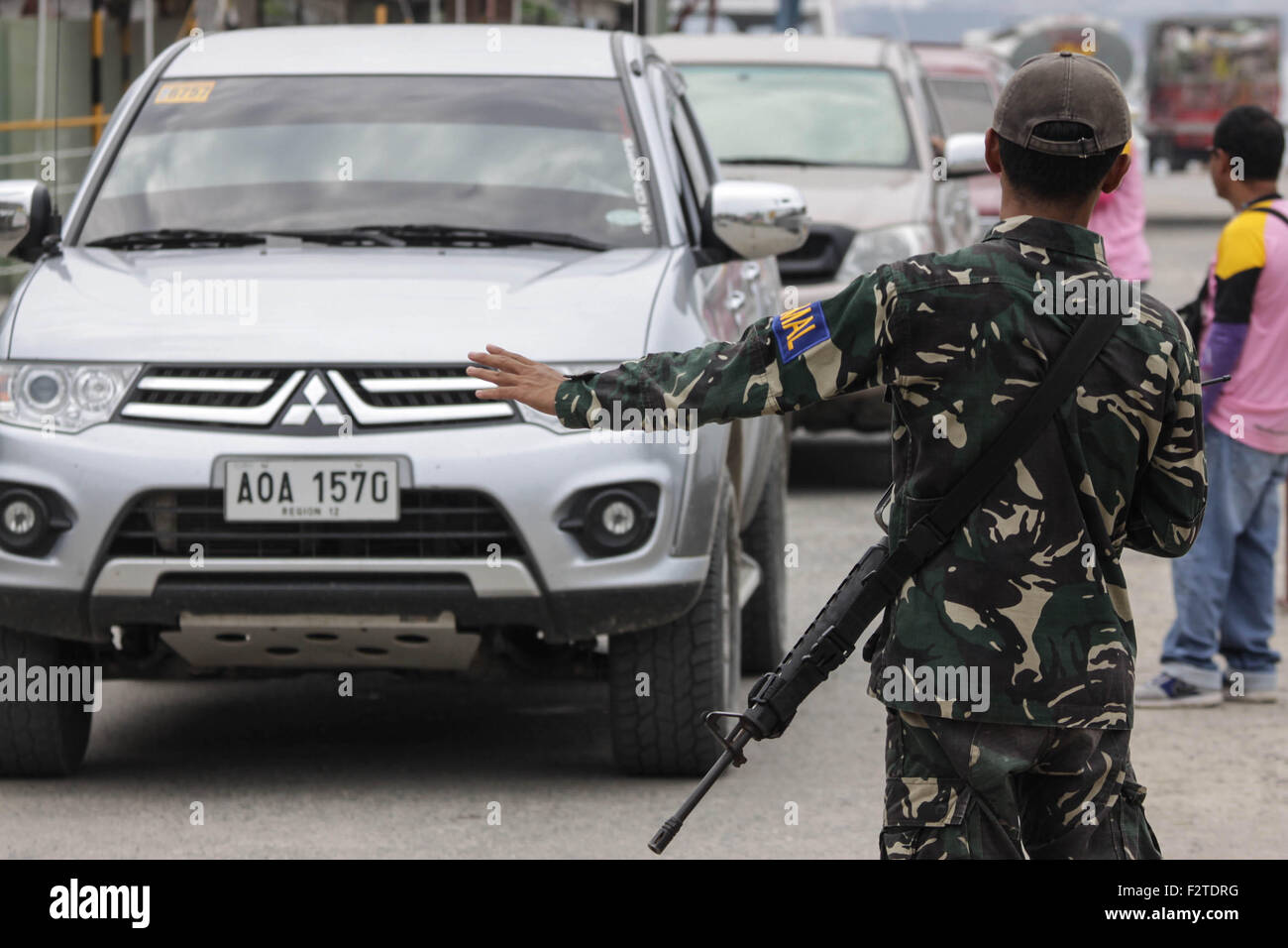 A military stops vehicle for inspection. A military checkpoint is set ...