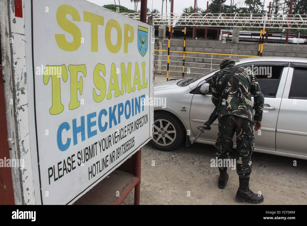 A military inspects vehicle heading to Samal Island . Rigid security ...