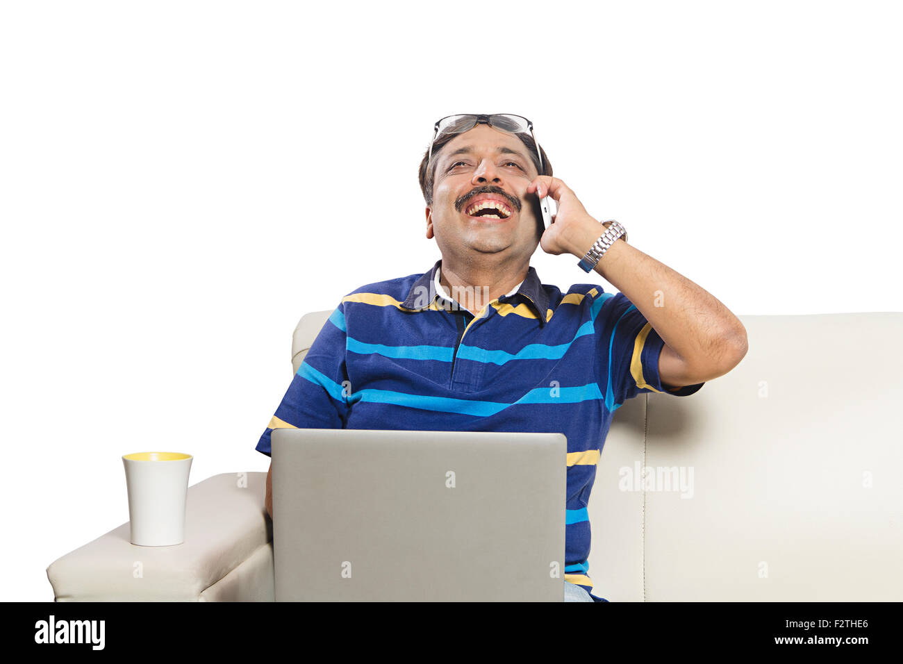 1 indian Adult Man Laptop and Mobile Phone talking Multi Tasking Stock ...