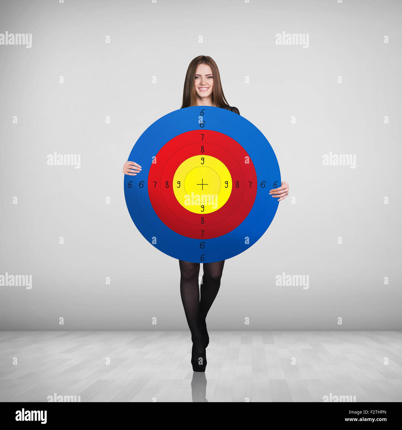 Business woman holding big target Stock Photo - Alamy
