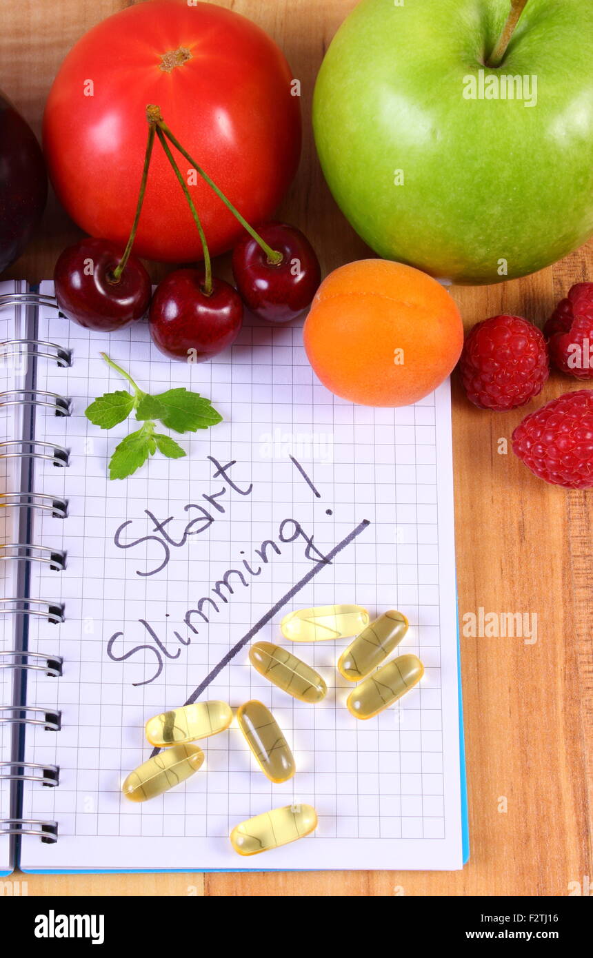 Fresh fruits, vegetables and tablets supplements with notebook for ...