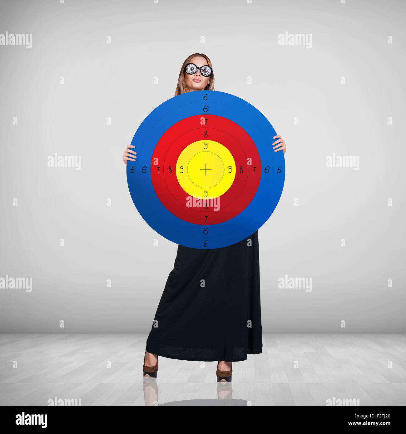 Business woman holding big target Stock Photo - Alamy