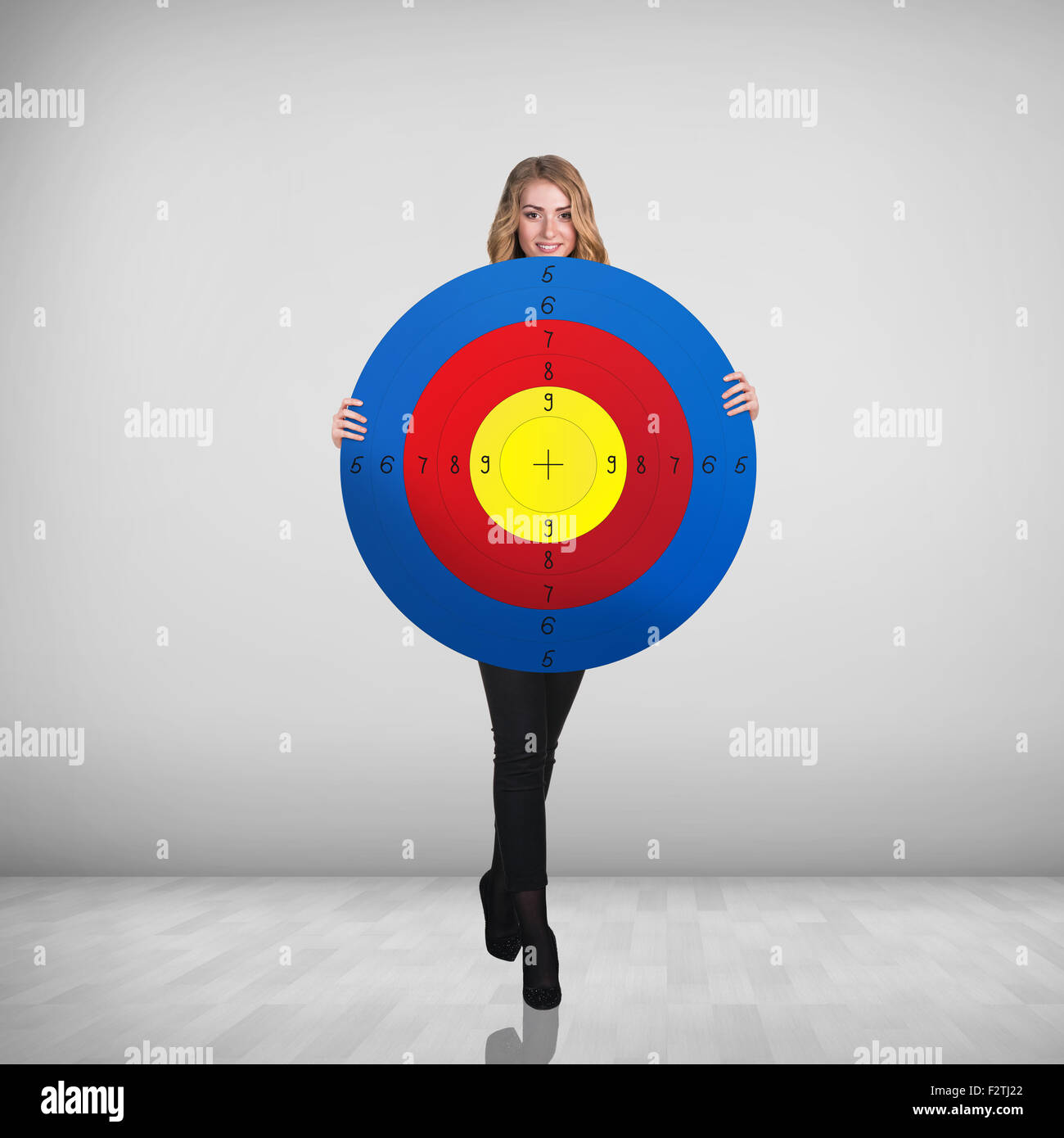 Business woman holding big target Stock Photo - Alamy