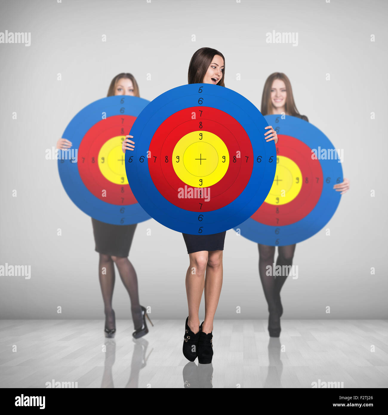 Business women smiling and holding big target Stock Photo - Alamy Business women smiling and holding big target Stock Photo - Alamy