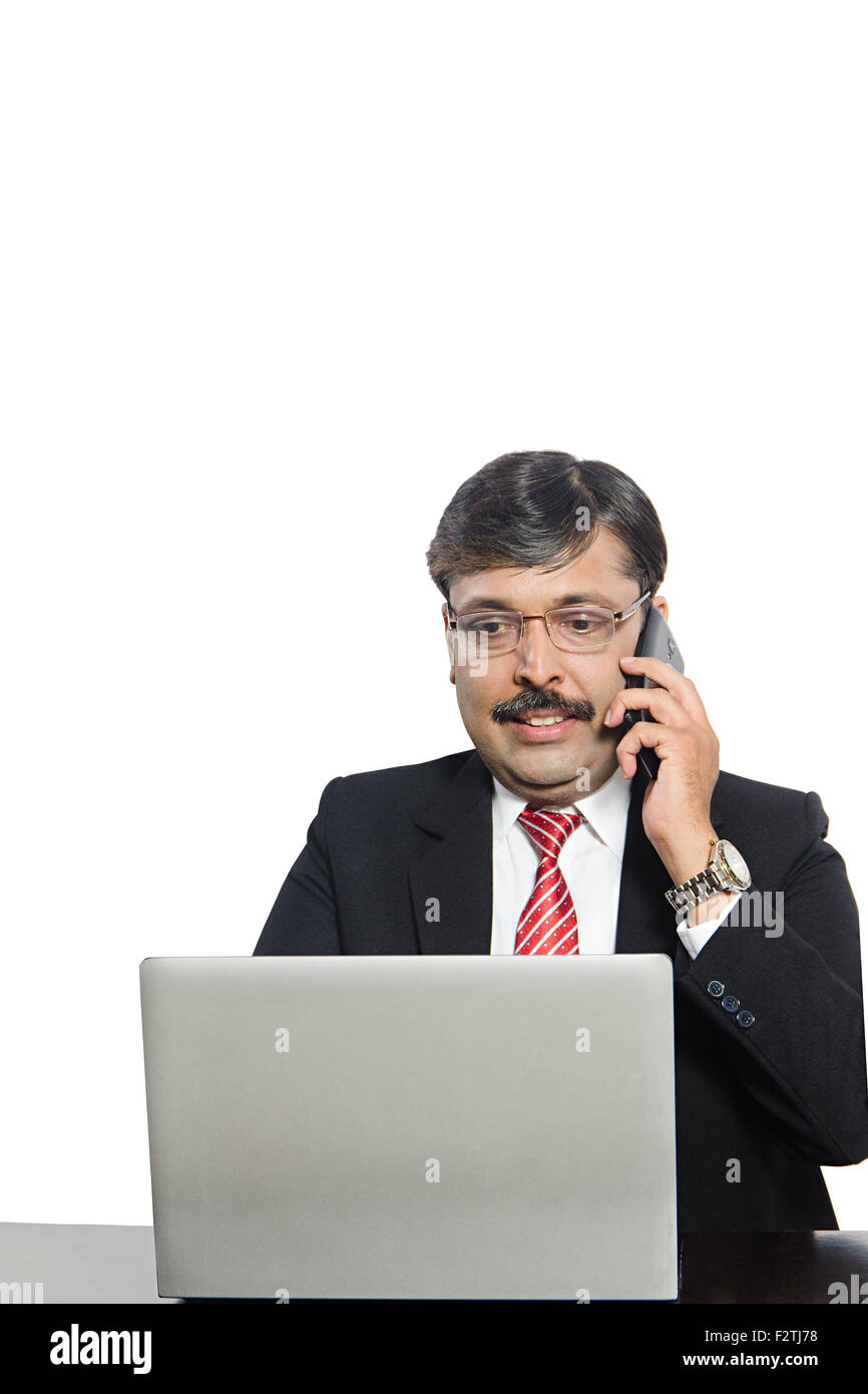 1 indian Business Man Laptop and Mobile Phone talking Multi Tasking ...