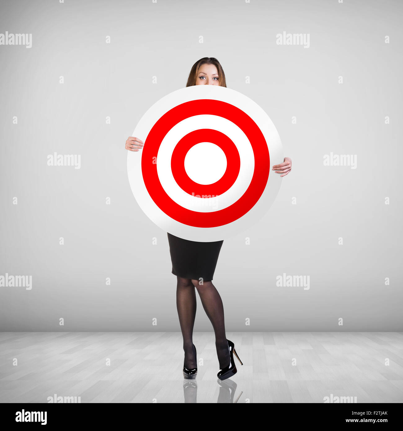 Business woman holding big target Stock Photo - Alamy