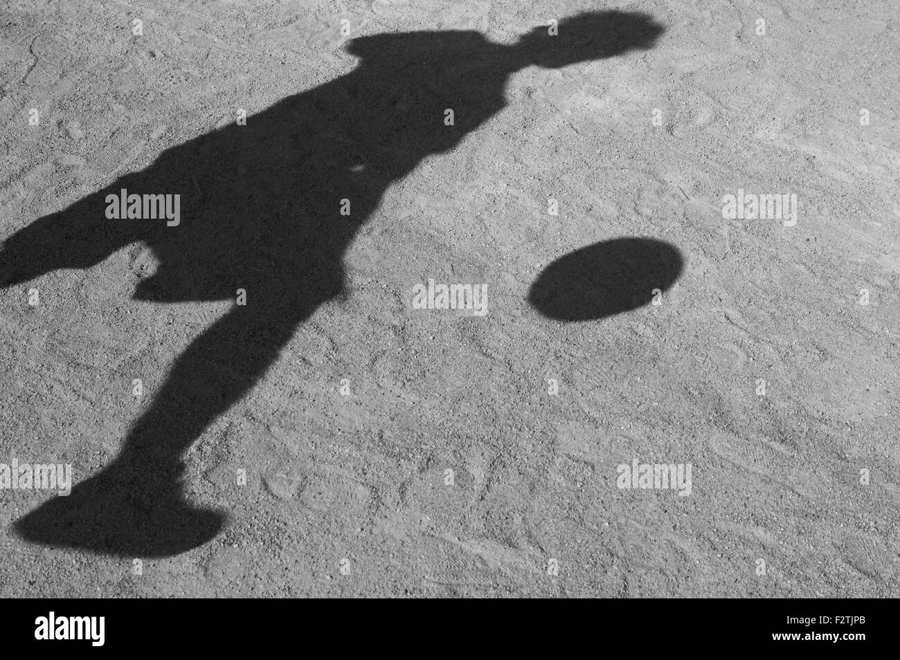 Shadow of a football player reflected on sand Stock Photo - Alamy
