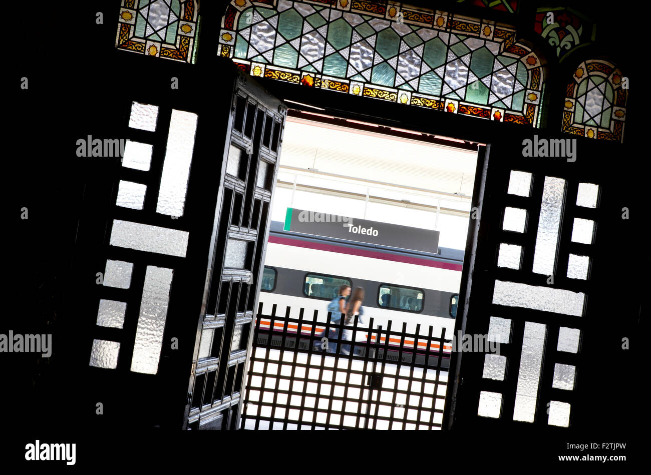 Railway station signpost with train and passengers Stock Photo - Alamy