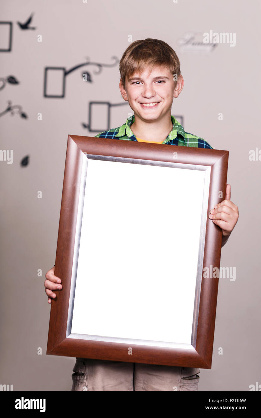 Happy young boy holding portrait frame Stock Photo - Alamy