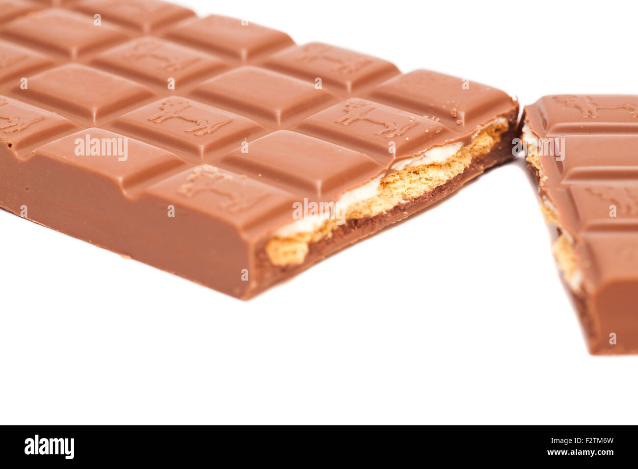 Broken chocolate bar on a white background Stock Photo - Alamy