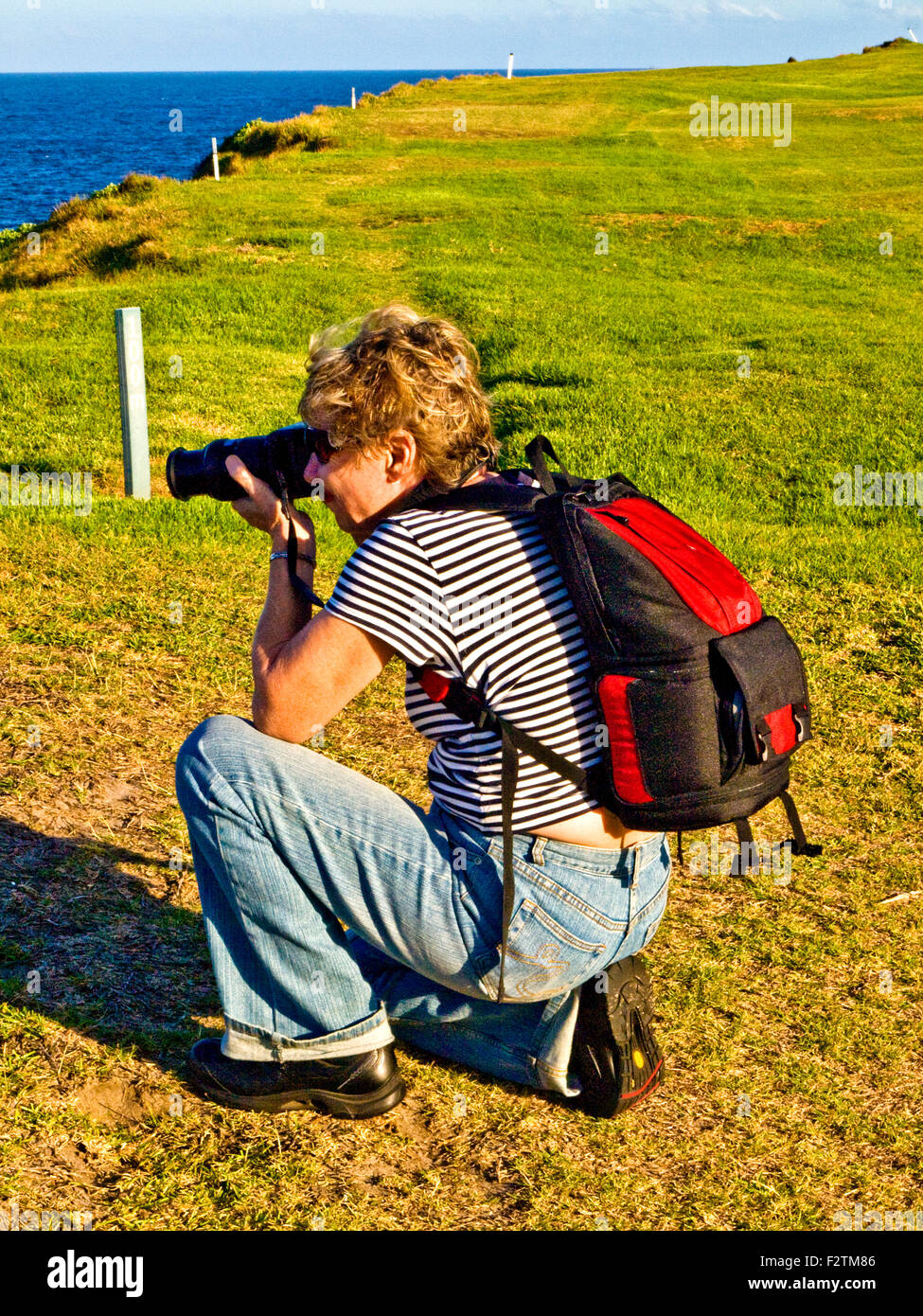 Lady photographer using DSLR showing stable position for camera in a ...
