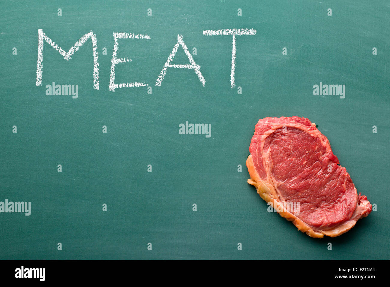 fresh raw beef on chalkboard Stock Photo - Alamy