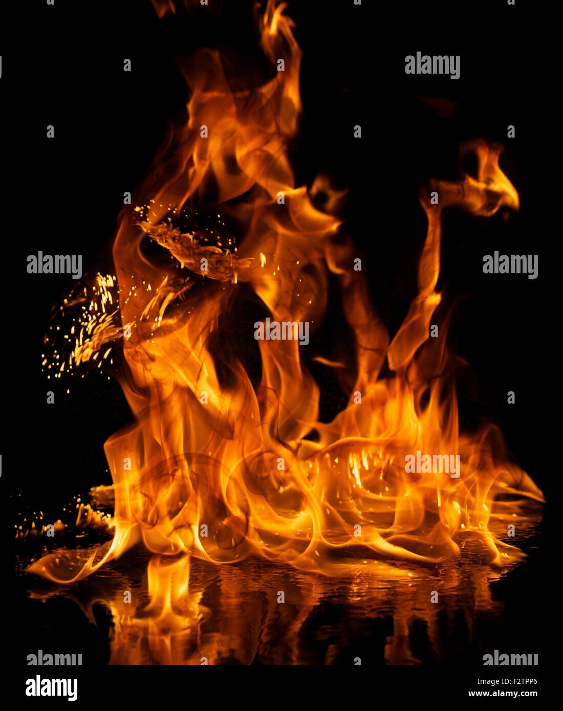 Fire flames reflected in water Stock Photo - Alamy