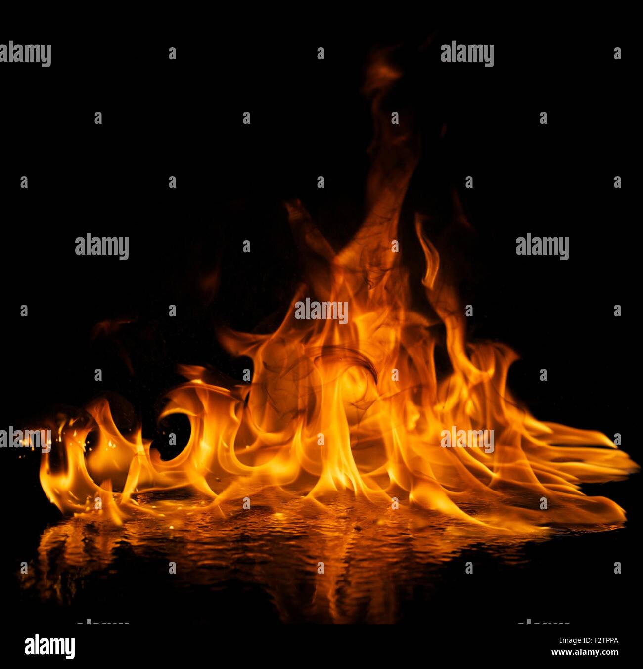 Fire flames reflected in water Stock Photo - Alamy