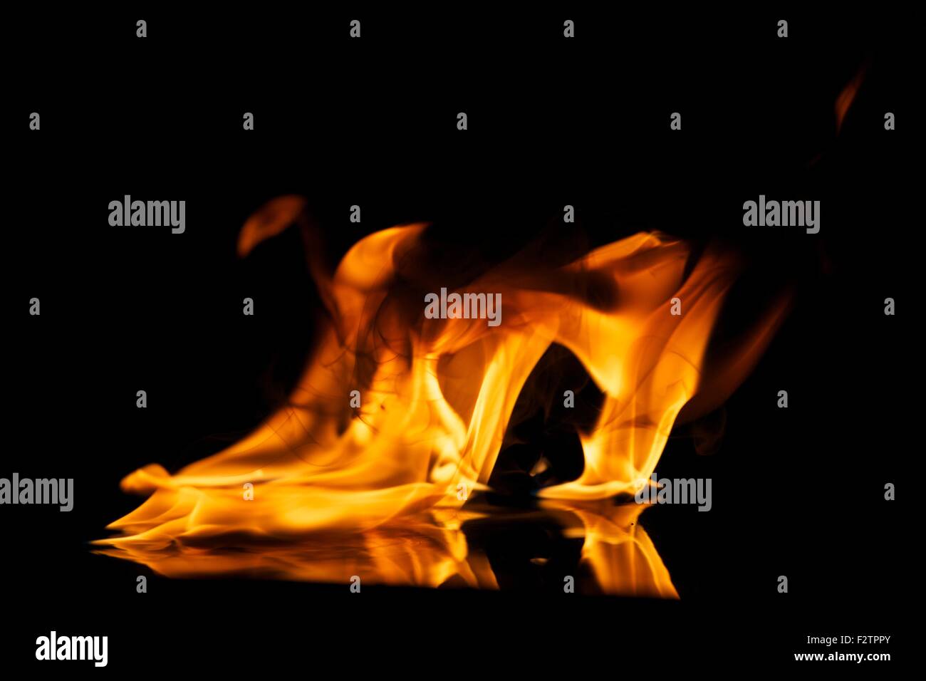 Fire flames reflected in water Stock Photo - Alamy