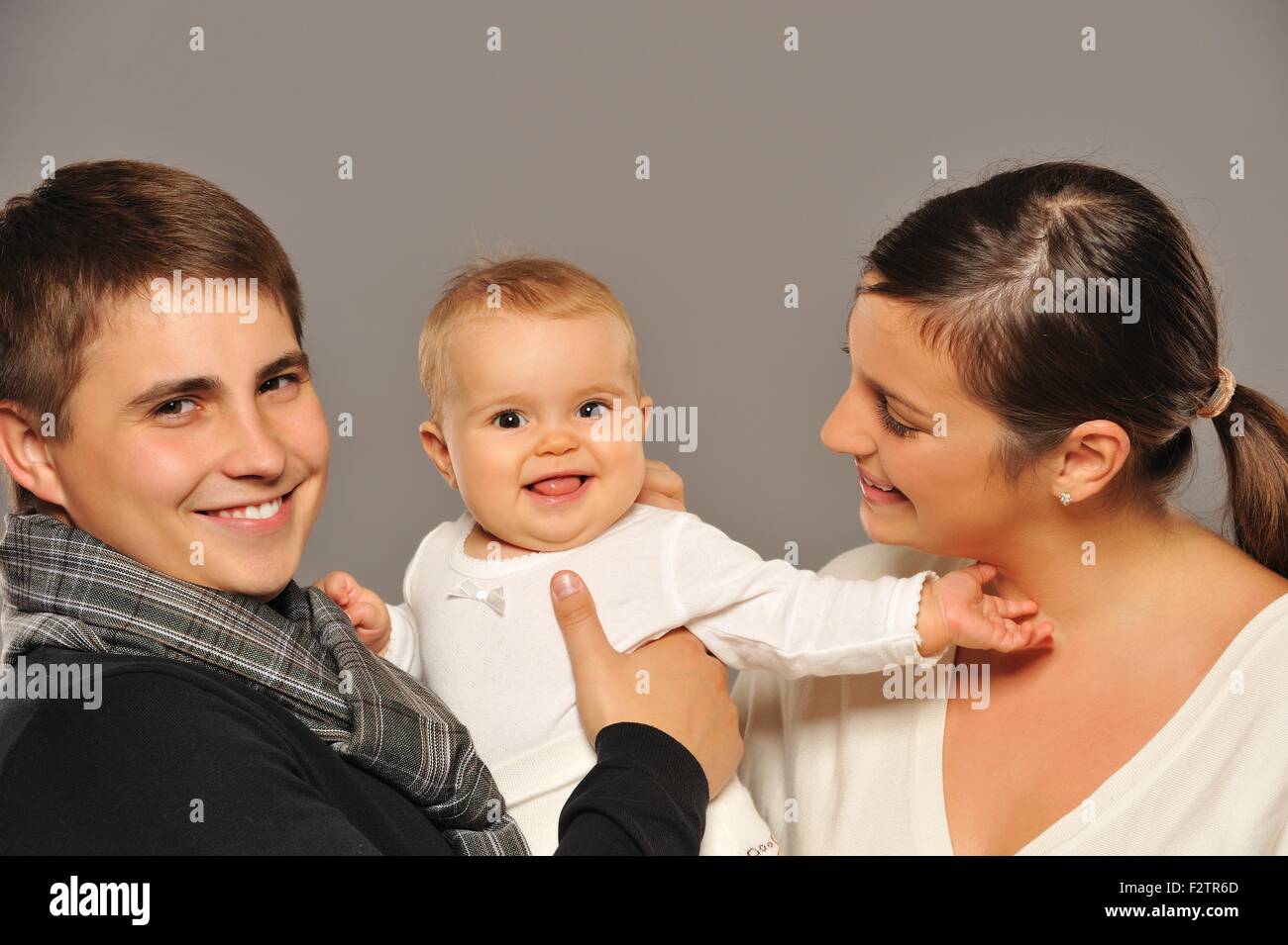 Happy family isolated on grey background Stock Photo - Alamy