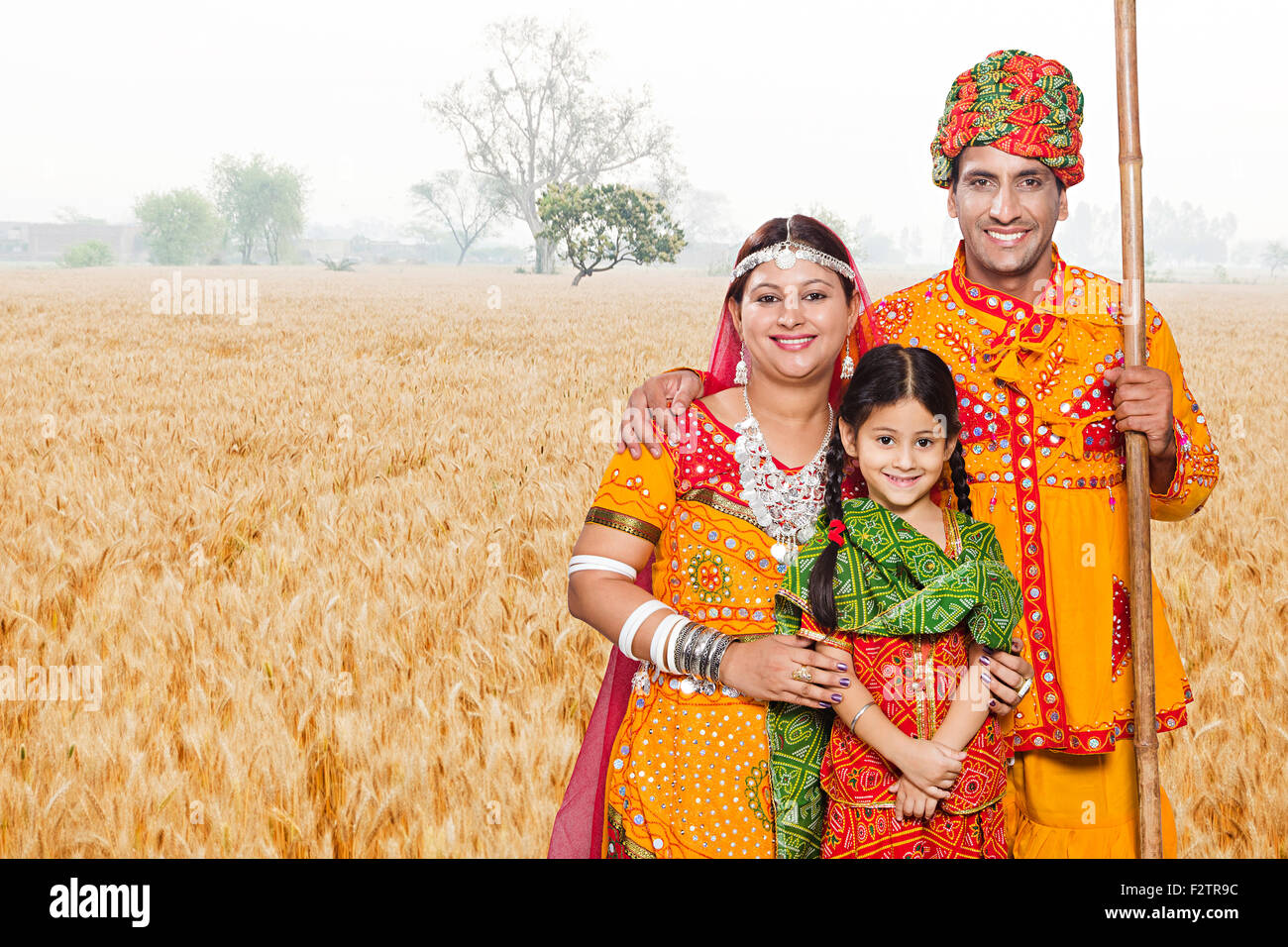 3 indian Rajasthani Villager Parents and daughter standing farm Stock ...
