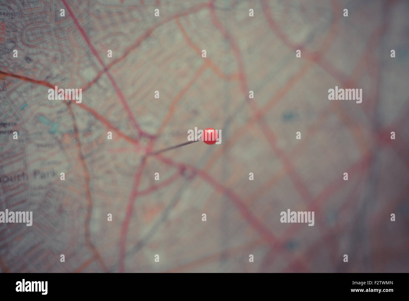 A red pin placed on a city map Stock Photo - Alamy