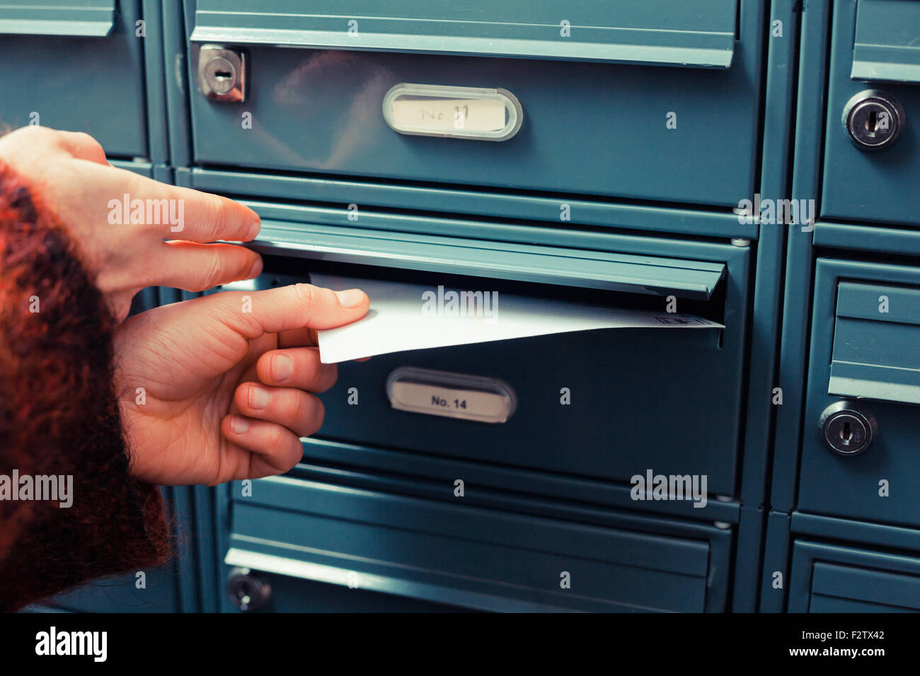 Closeup on a female hand putting a letter in a letterbox Stock Photo ...
