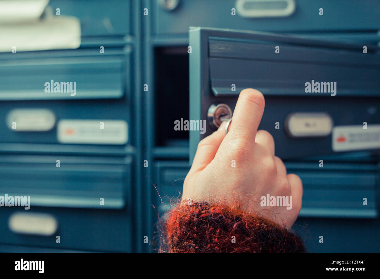 Closeup on a woman's hand as she is getting her post out of her ...