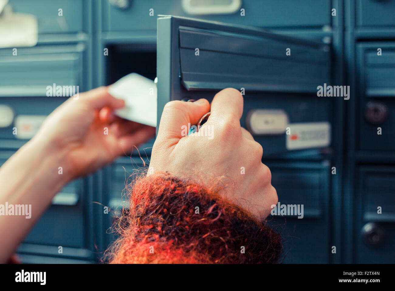 Closeup on a woman's hand as she is getting her post out of her ...