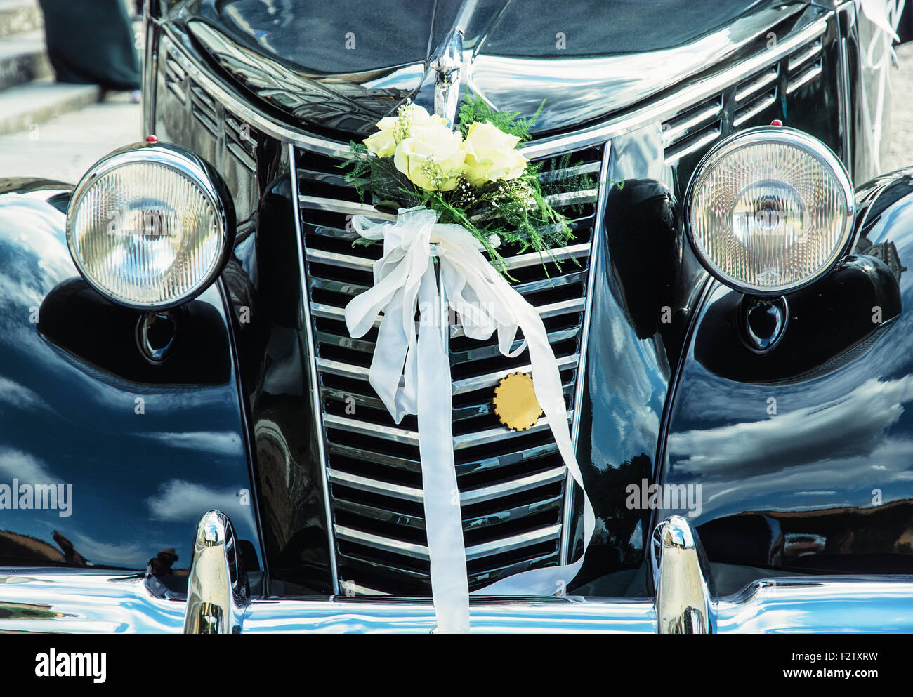 Front view of historical wedding car with ribbon and flowers. Symbol of ...