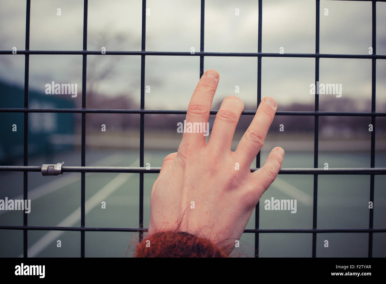 Human hand on fence hi-res stock photography and images - Alamy